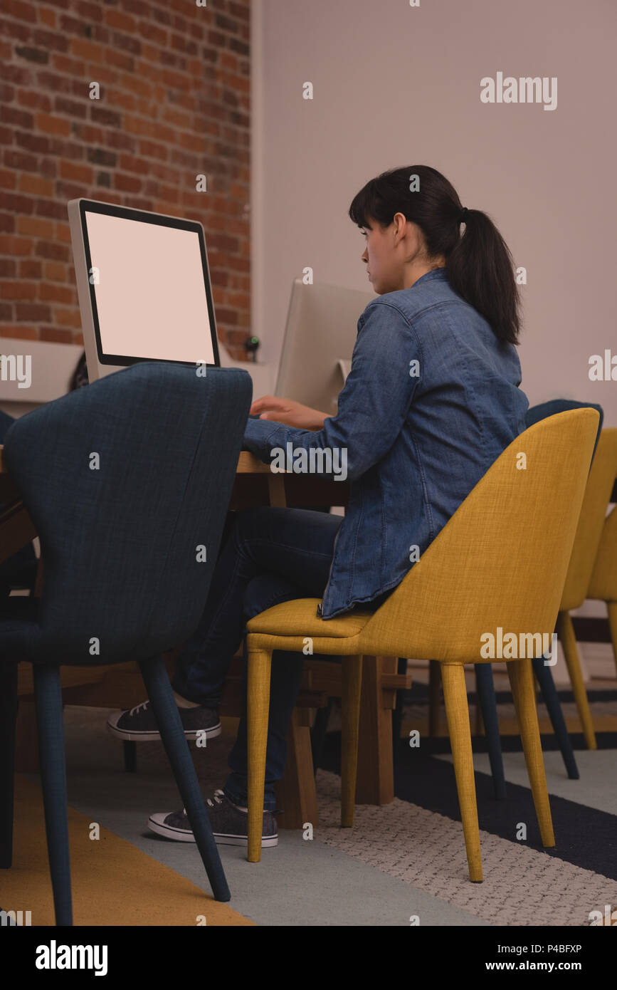 Female executive working on computer Stock Photo - Alamy