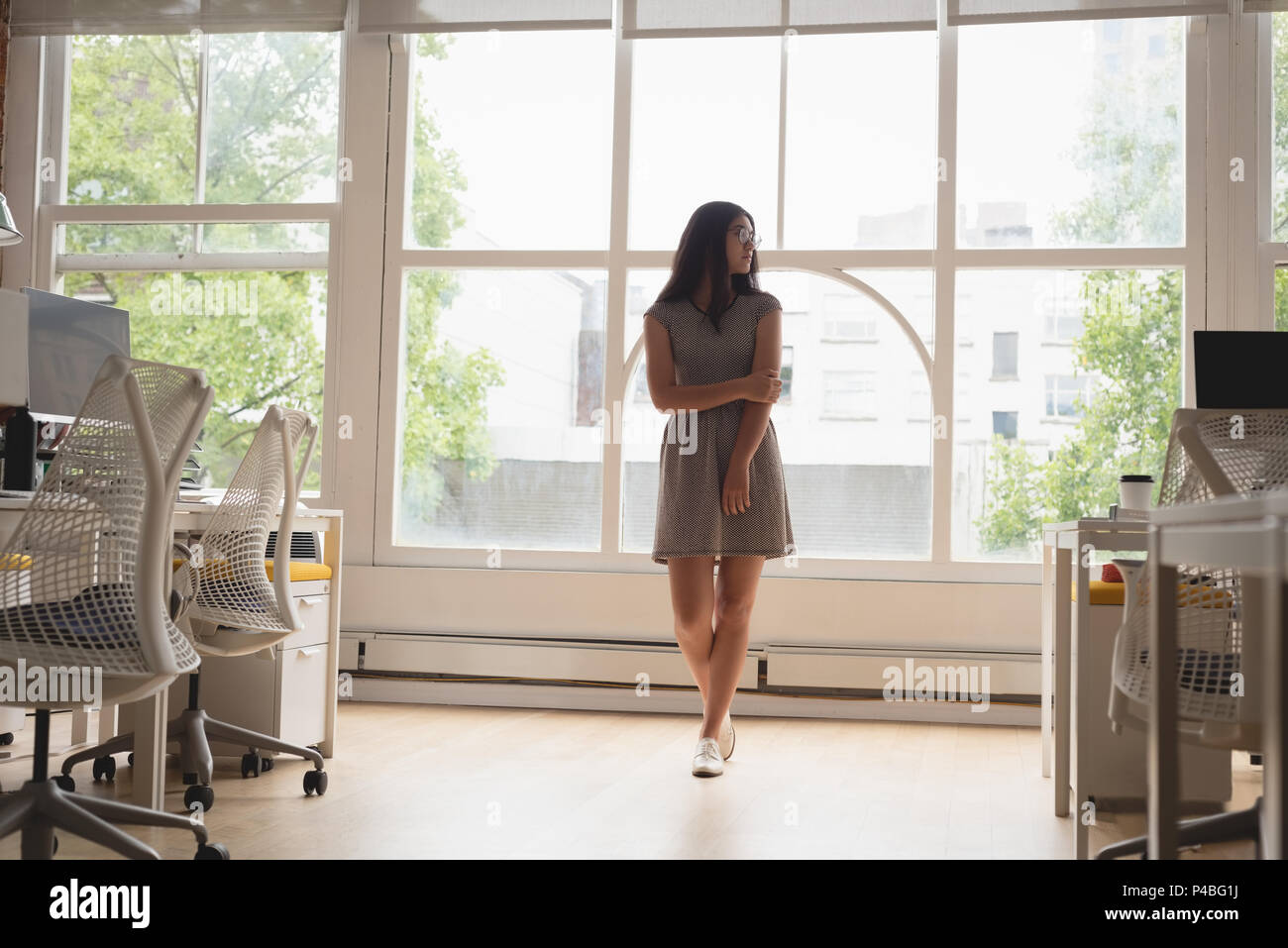 Female executive standing in the office Stock Photo - Alamy