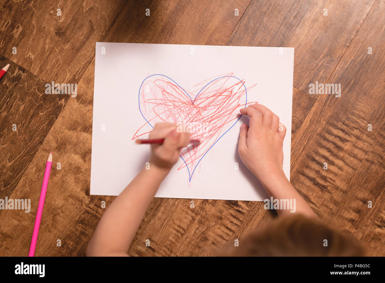 Girl drawing on craft paper Stock Photo - Alamy