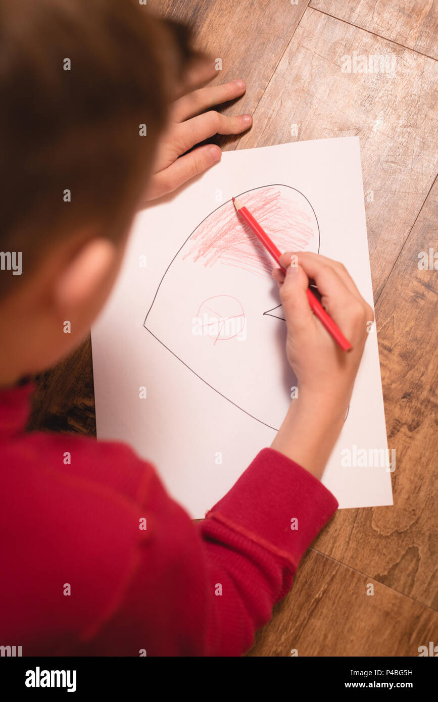 Boy drawing on craft paper Stock Photo - Alamy