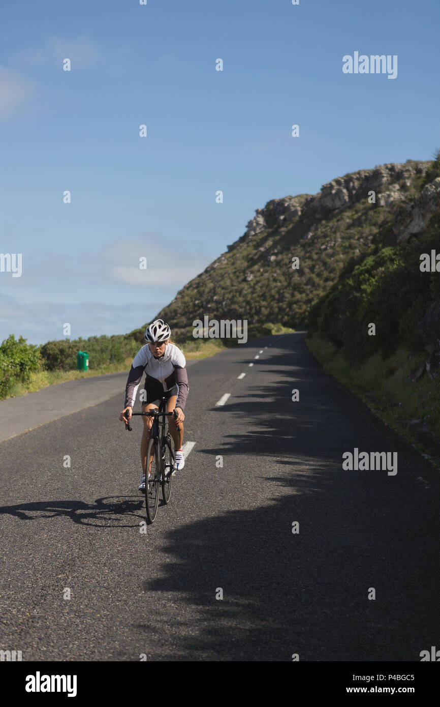 Biker riding mountain bike on road Stock Photo - Alamy