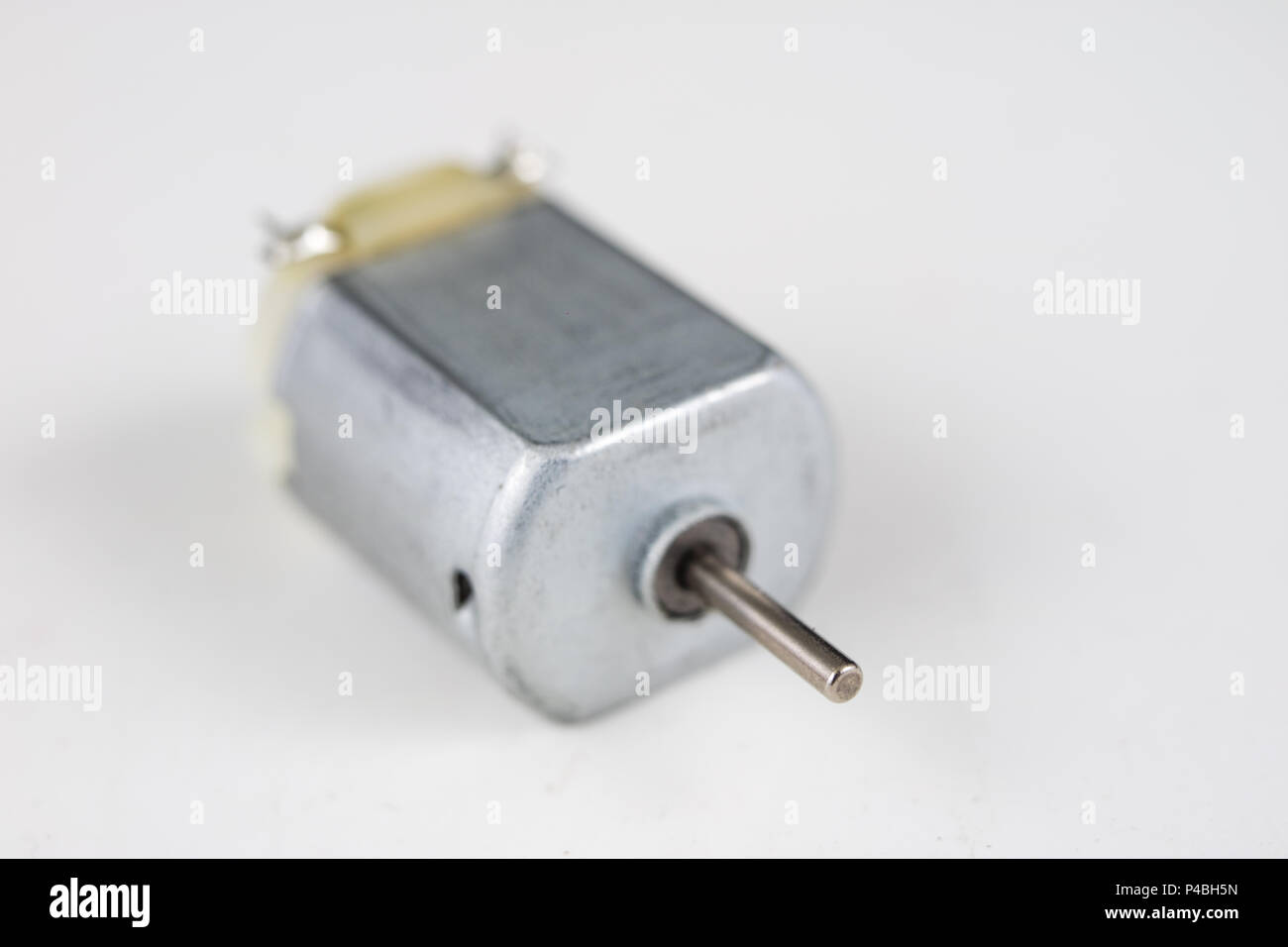 Small electric motor on a white workshop table. Electric drive used in ...