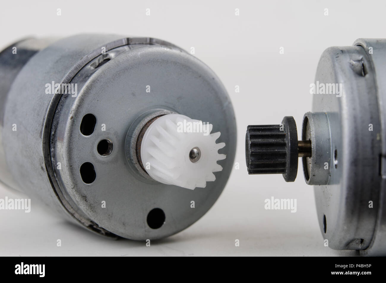 Small electric motor on a white workshop table. Electric drive used in ...