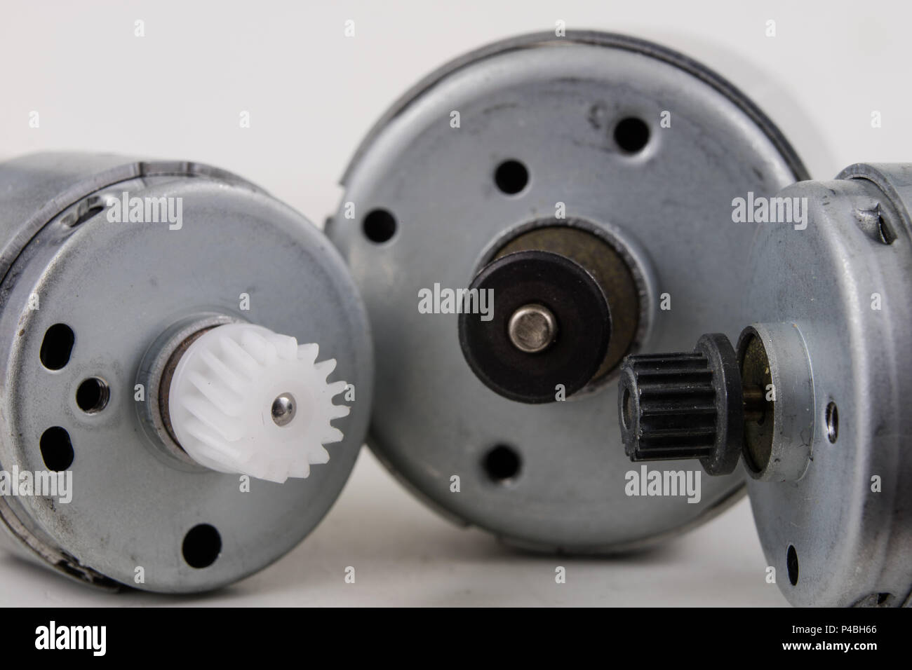 Small electric motor on a white workshop table. Electric drive used in ...