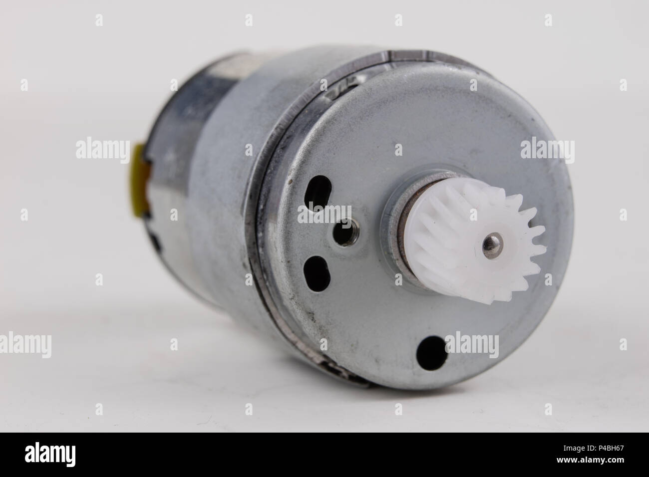 Small electric motor on a white workshop table. Electric drive used in ...