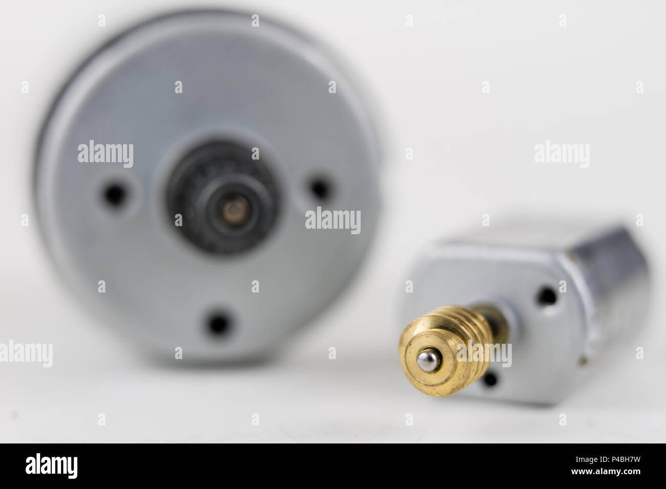 Small electric motor on a white workshop table. Electric drive used in ...