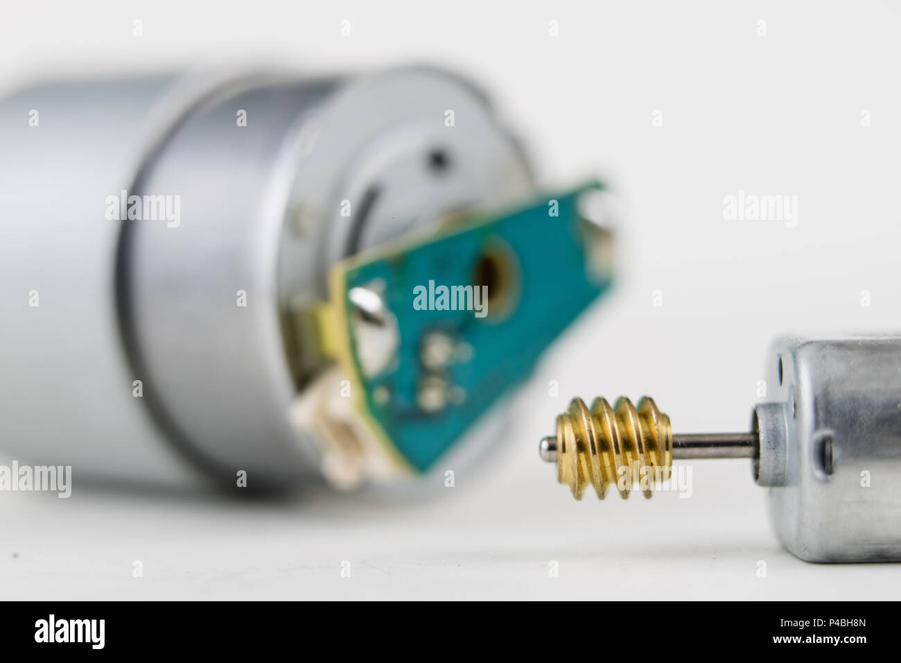 Small electric motor on a white workshop table. Electric drive used in ...