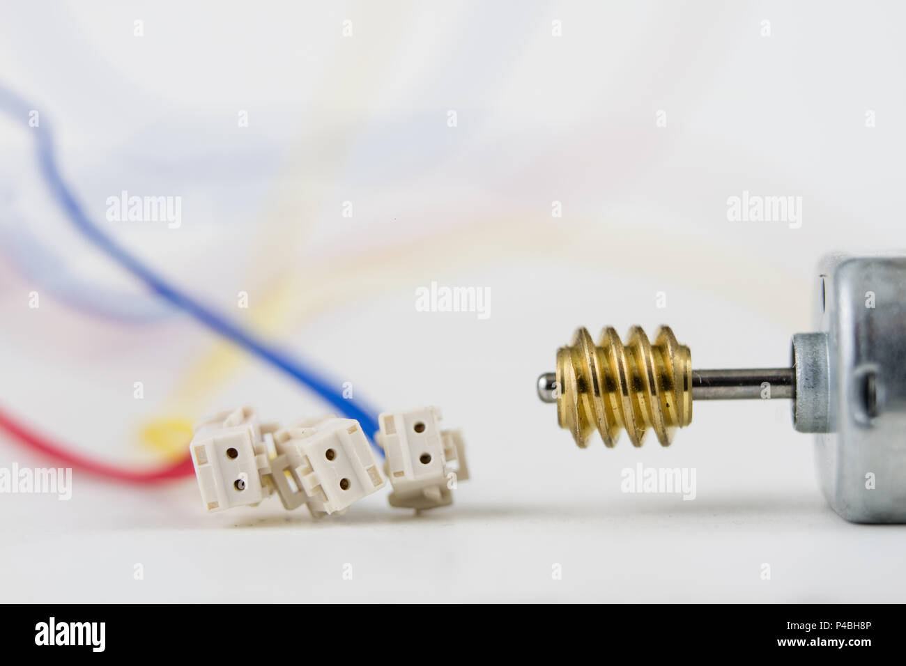 Small electric motor on a white workshop table. Electric drive used in ...