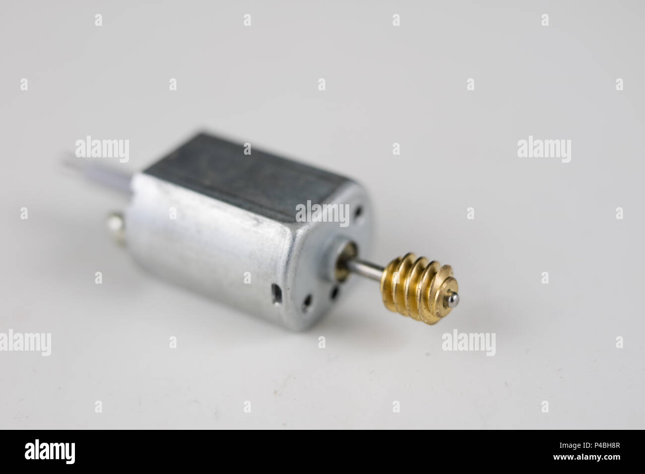 Small electric motor on a white workshop table. Electric drive used in ...