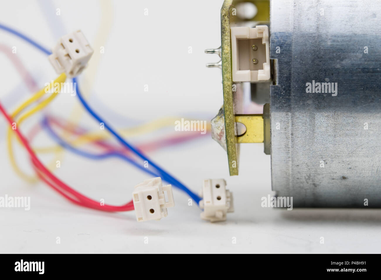 Small electric motor on a white workshop table. Electric drive used in ...