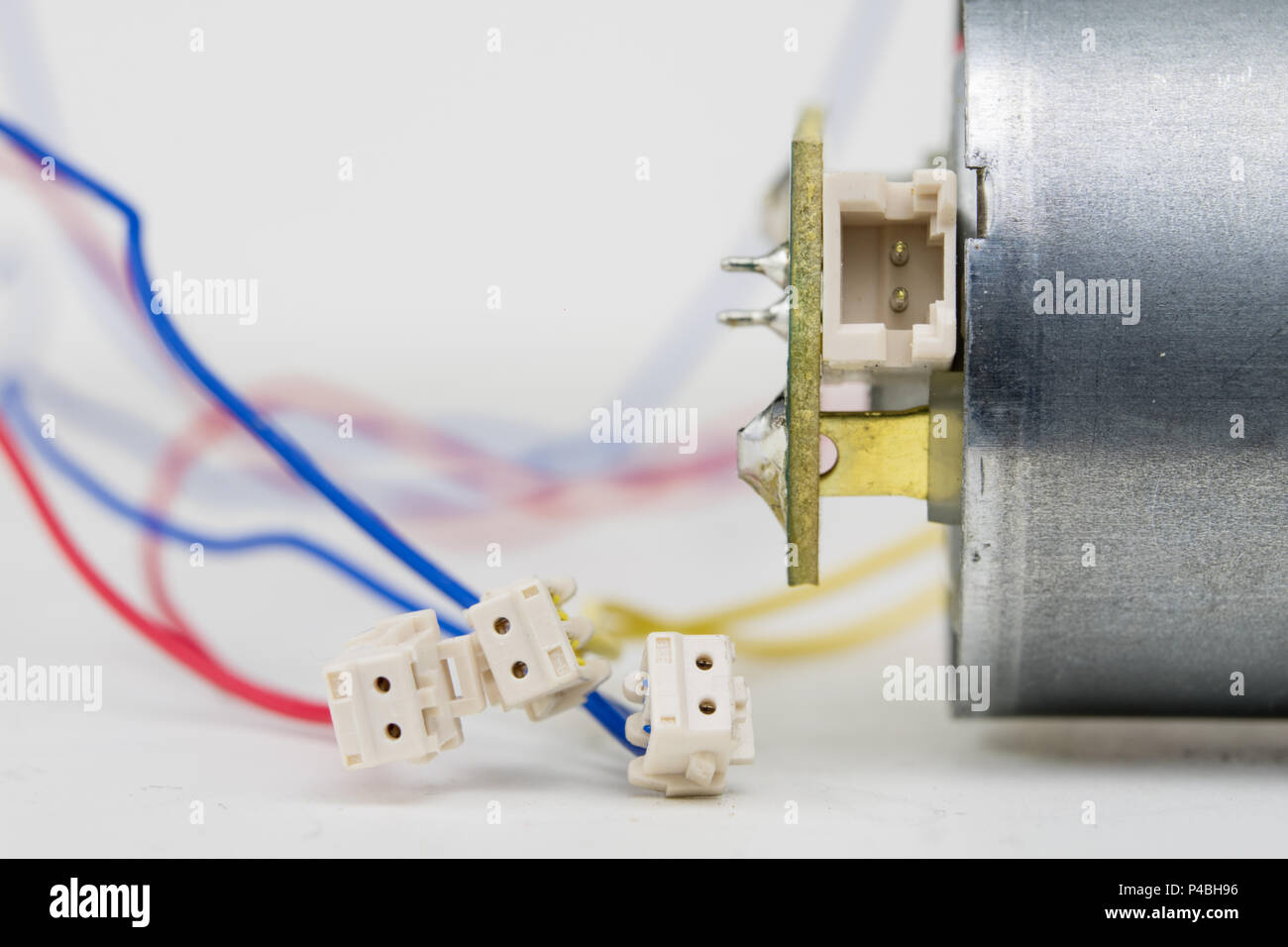 Small electric motor on a white workshop table. Electric drive used in ...