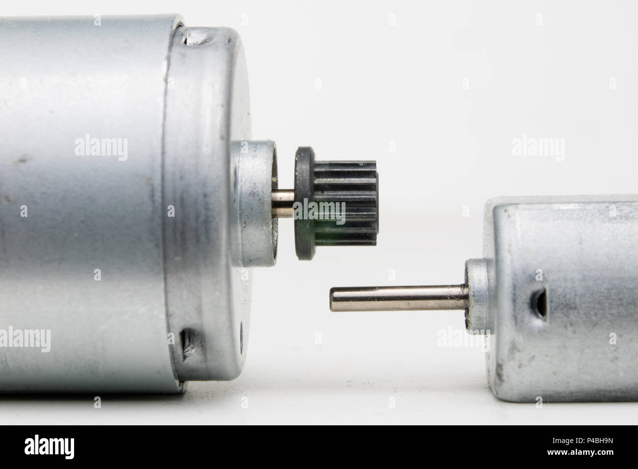 Small electric motor on a white workshop table. Electric drive used in ...