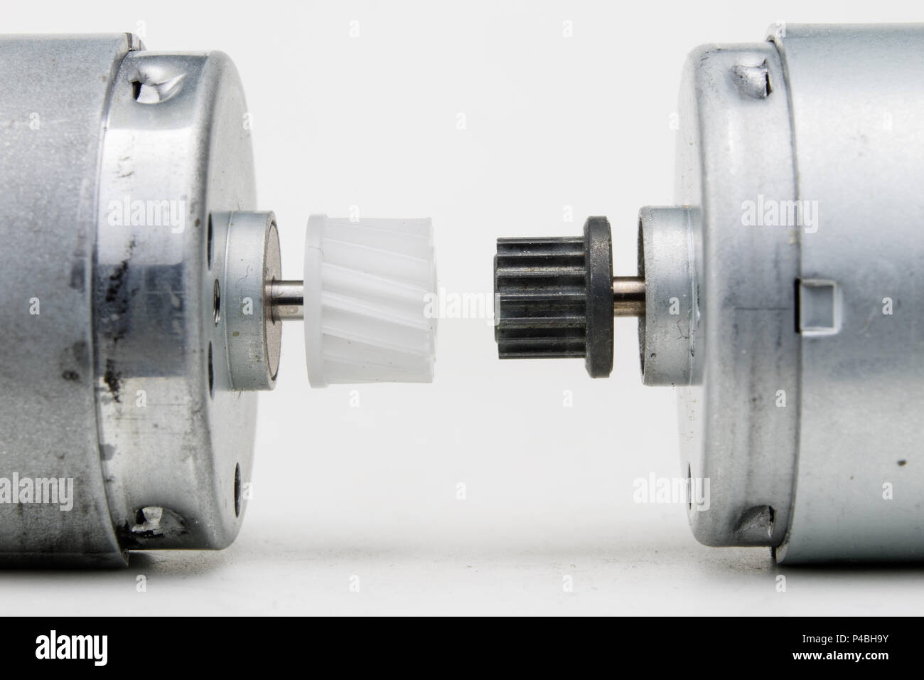 Small electric motor on a white workshop table. Electric drive used in ...