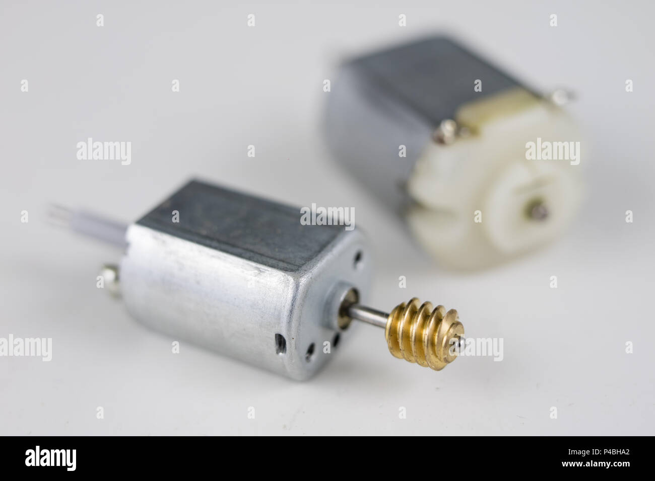 Small electric motor on a white workshop table. Electric drive used in ...