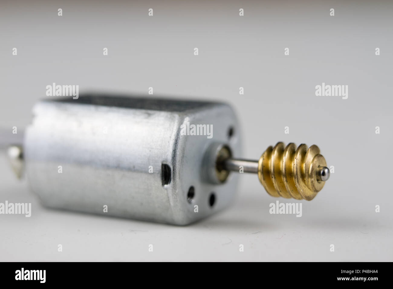 Small electric motor on a white workshop table. Electric drive used in ...