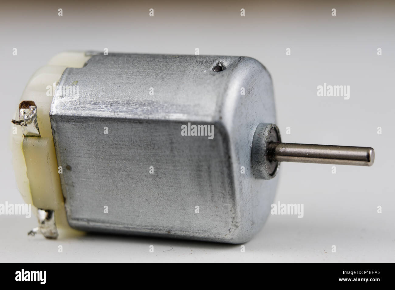 Small electric motor on a white workshop table. Electric drive used in ...
