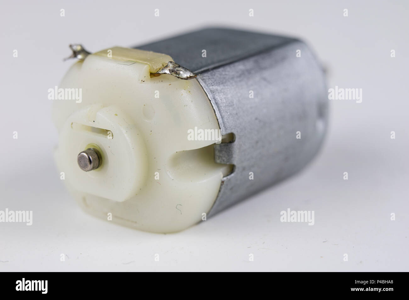 Small electric motor on a white workshop table. Electric drive used in ...