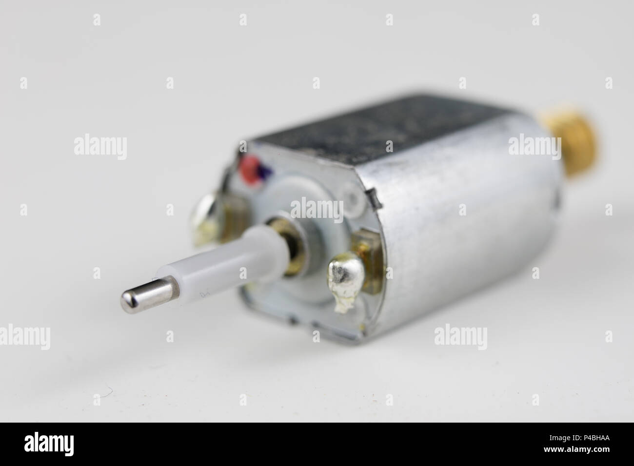 Small electric motor on a white workshop table. Electric drive used in ...