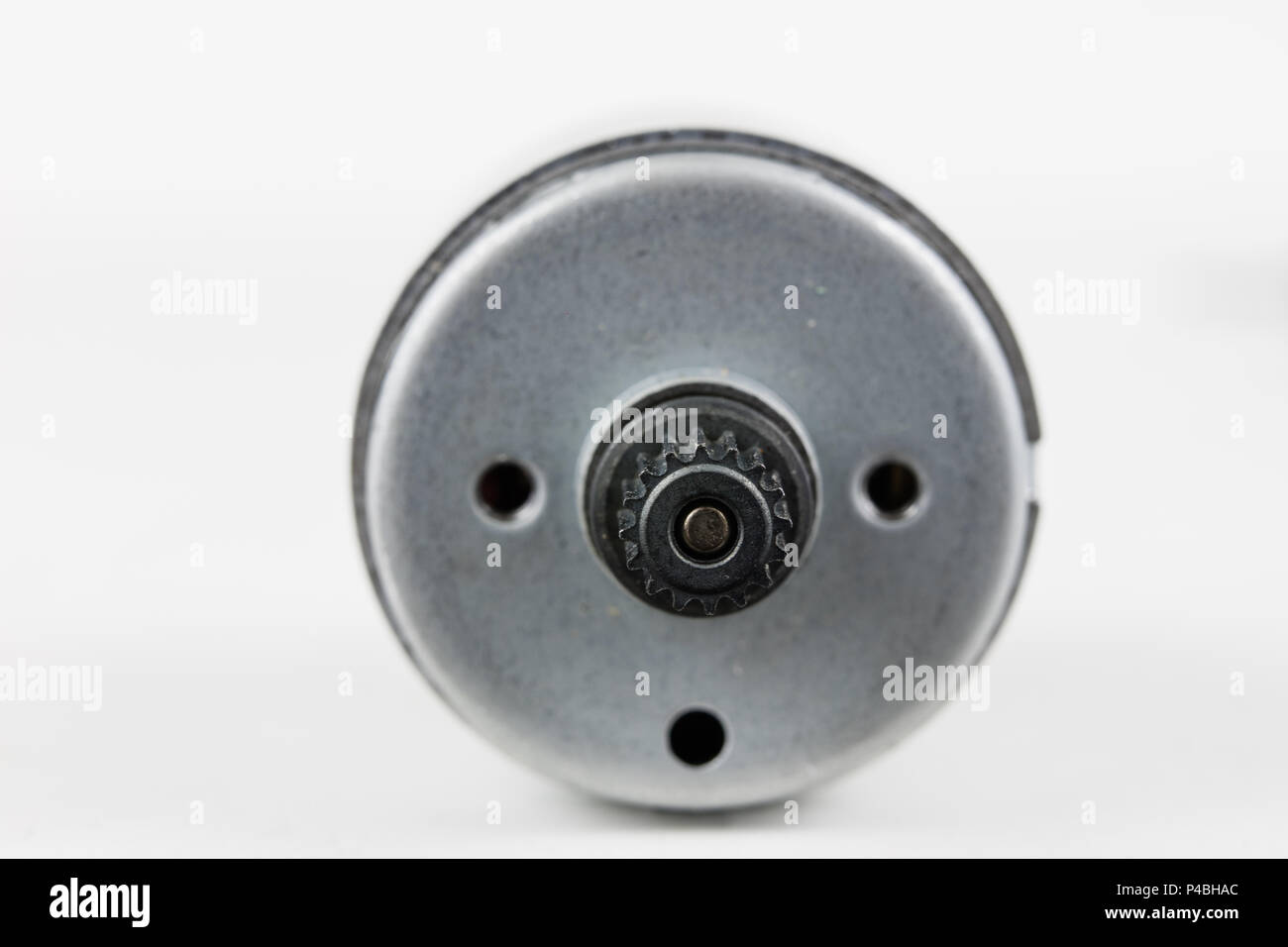 Small electric motor on a white workshop table. Electric drive used in ...