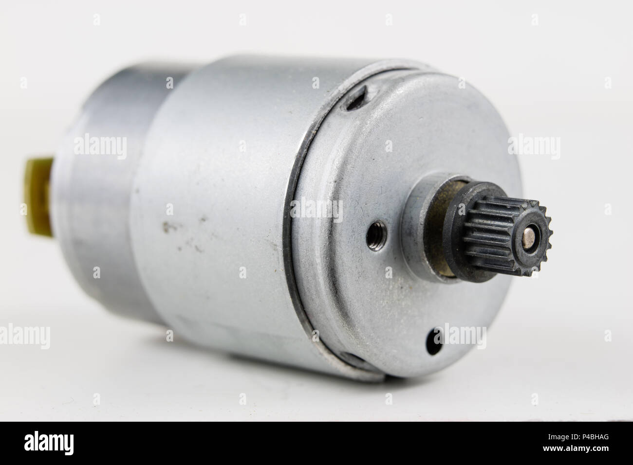 Small electric motor on a white workshop table. Electric drive used in ...