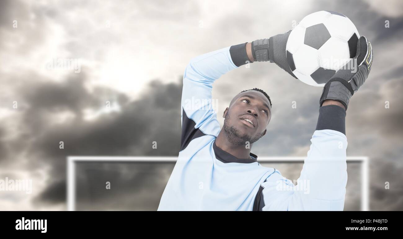 Soccer goalkeeper saving football in goal Stock Photo - Alamy