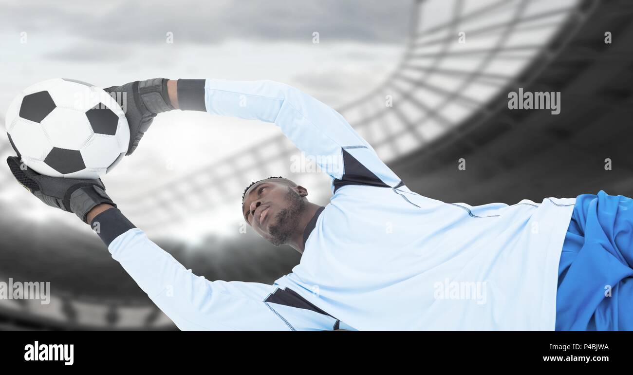 Soccer goalkeeper saving football Stock Photo - Alamy