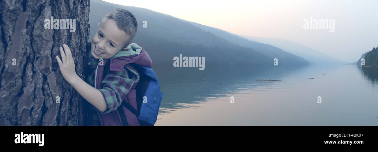 Boy touching tree hi-res stock photography and images - Alamy