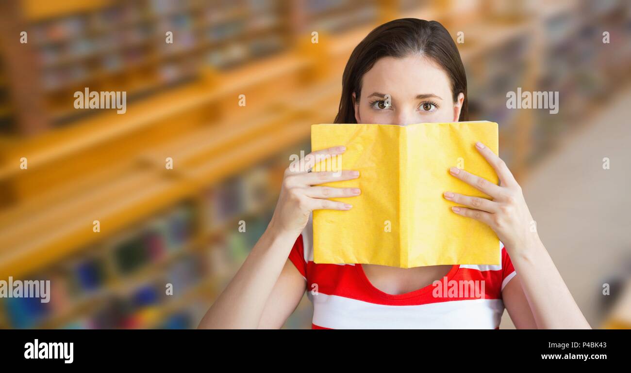 Woman looking over book hi-res stock photography and images - Alamy