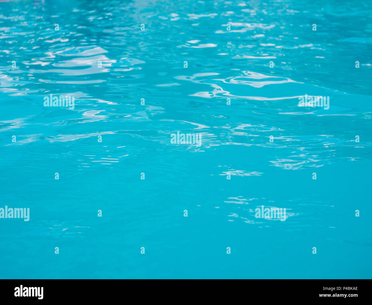 Blue water small ripple background in swimming pool Stock Photo - Alamy