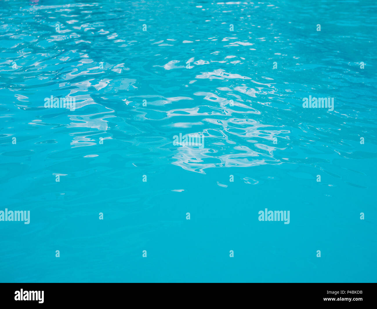 Blue water small ripple background in swimming pool Stock Photo - Alamy