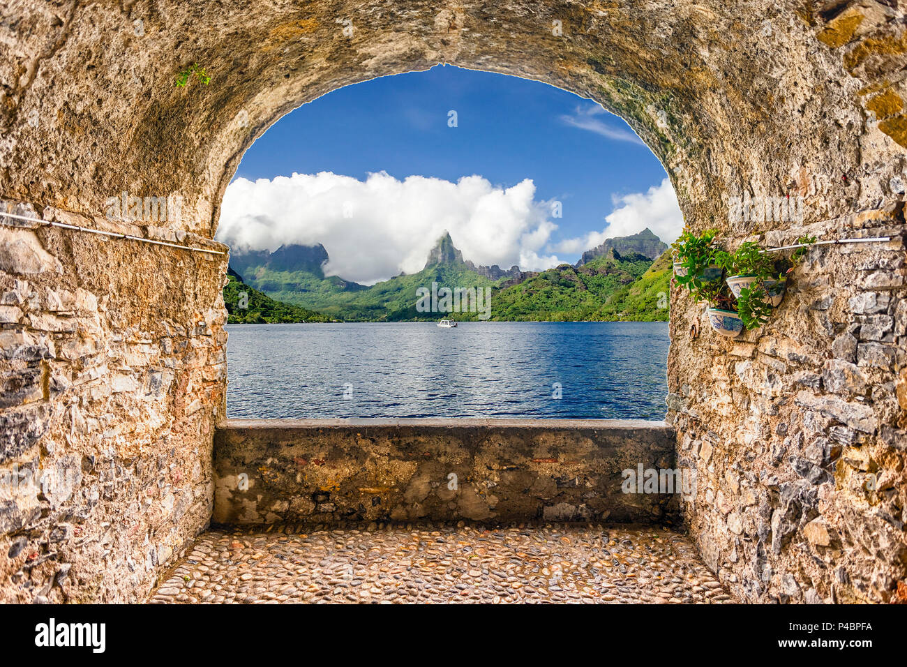 Scenic rock arch balcony overlooking a tropical beach in Moorea, French ...