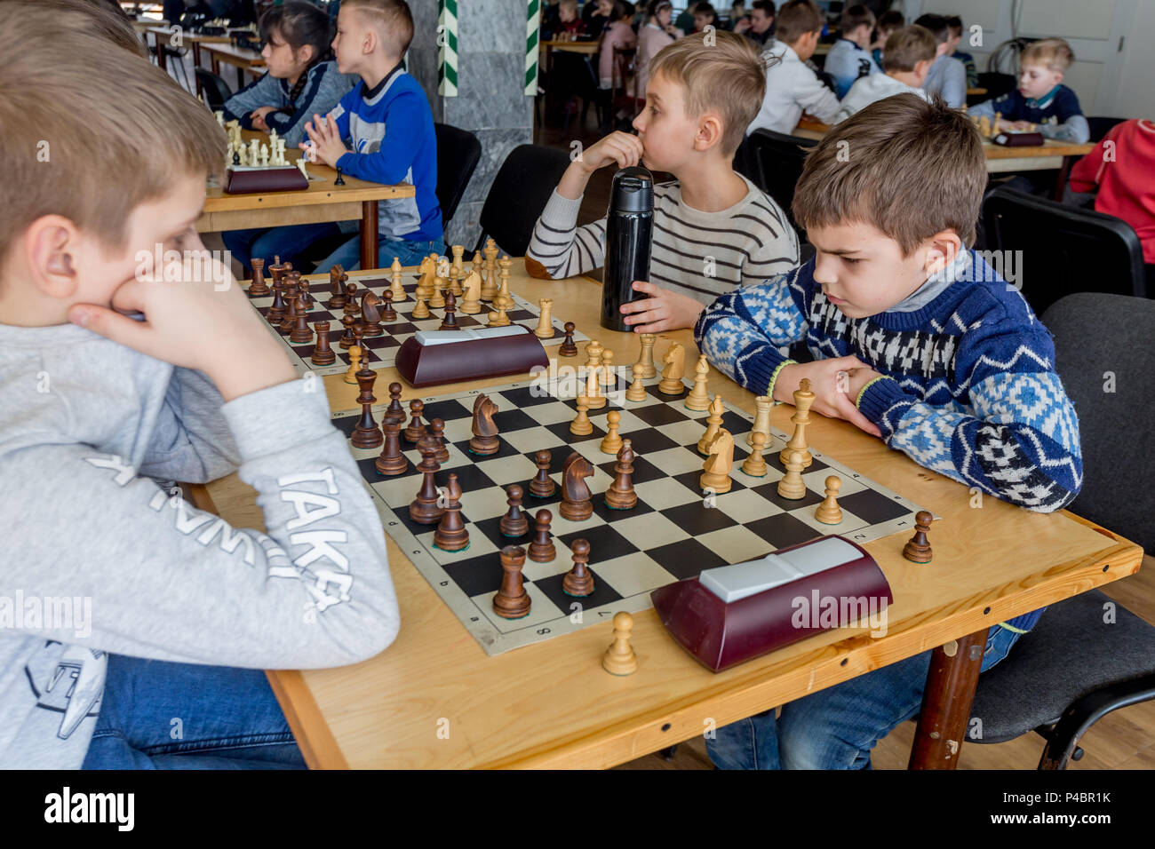 Russia, Vladivostok, 02/24/2018. Kids play chess during chess ...