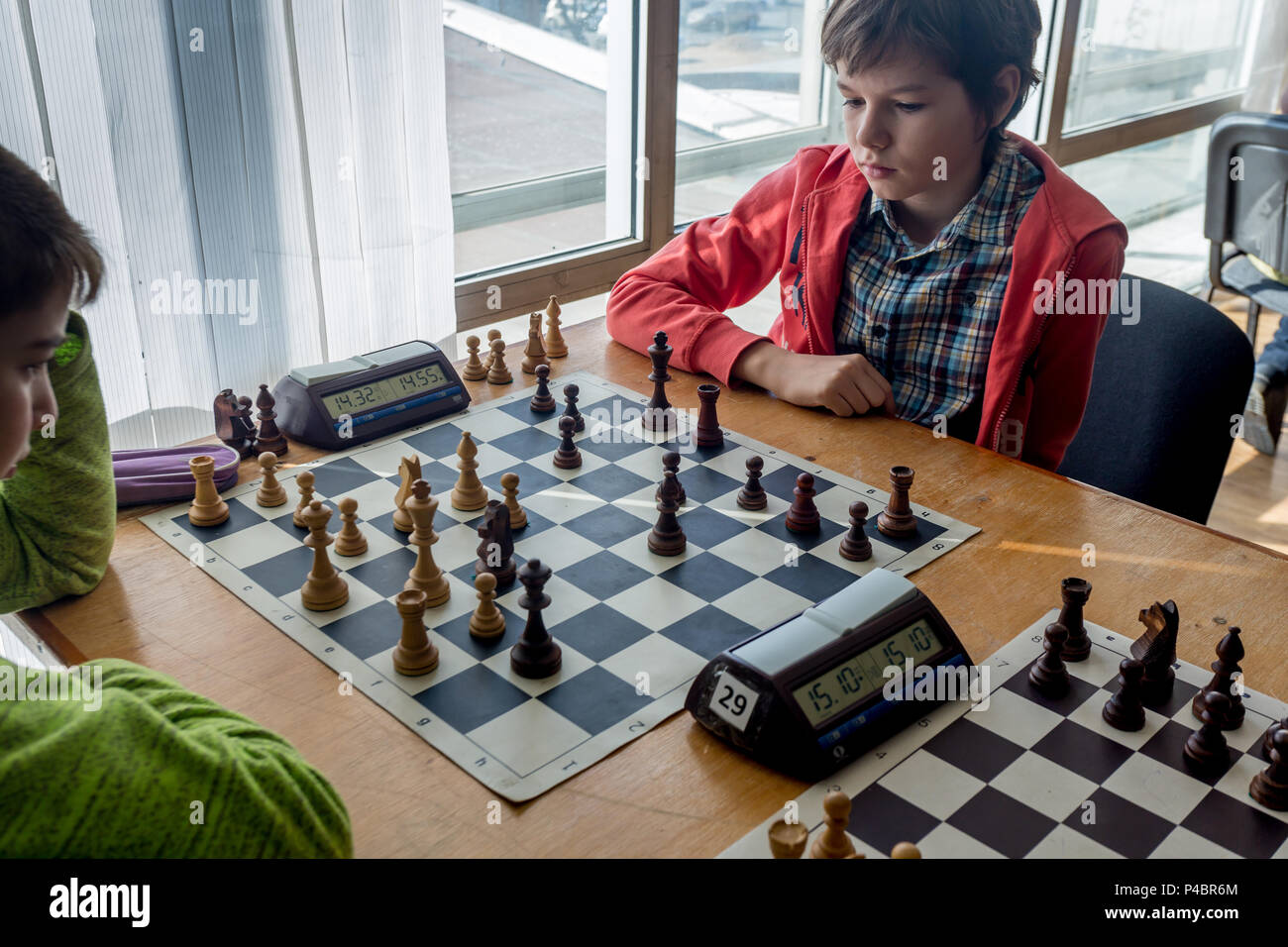 Russia, Vladivostok, 02/24/2018. Kids play chess during chess ...