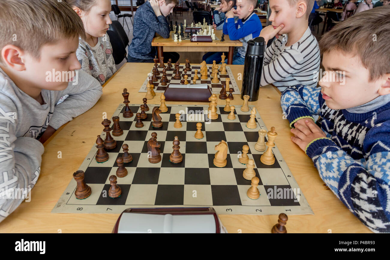 Russia, Vladivostok, 02/24/2018. Kids play chess during chess ...