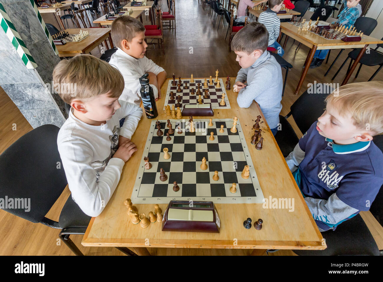 Russia, Vladivostok, 02/24/2018. Kids play chess during chess ...