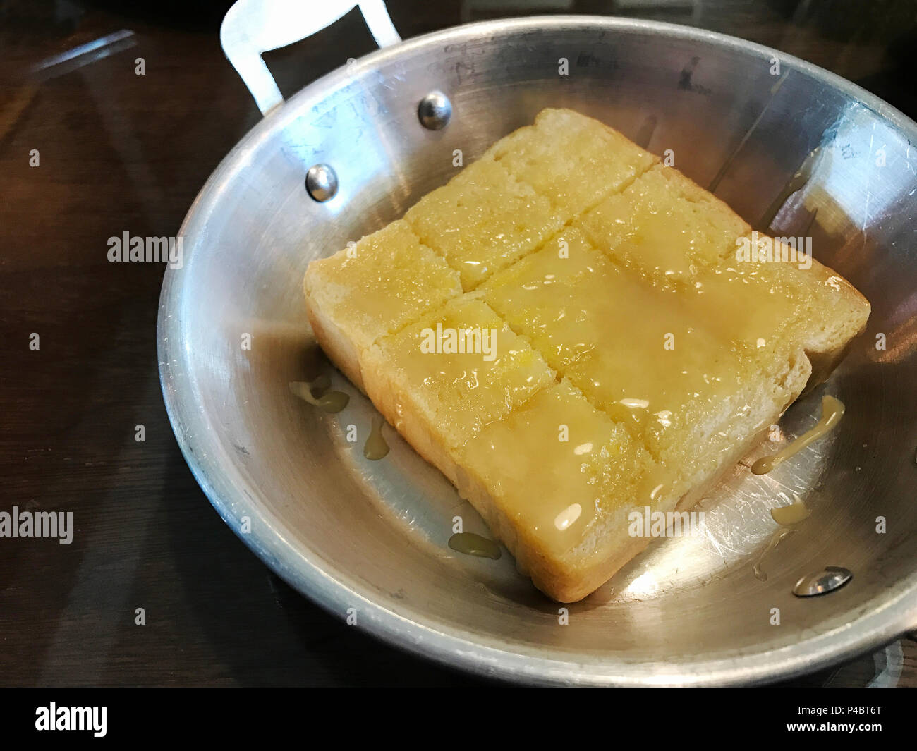 Toast bread one piece with butter milk sugar topping in the cafe Stock ...