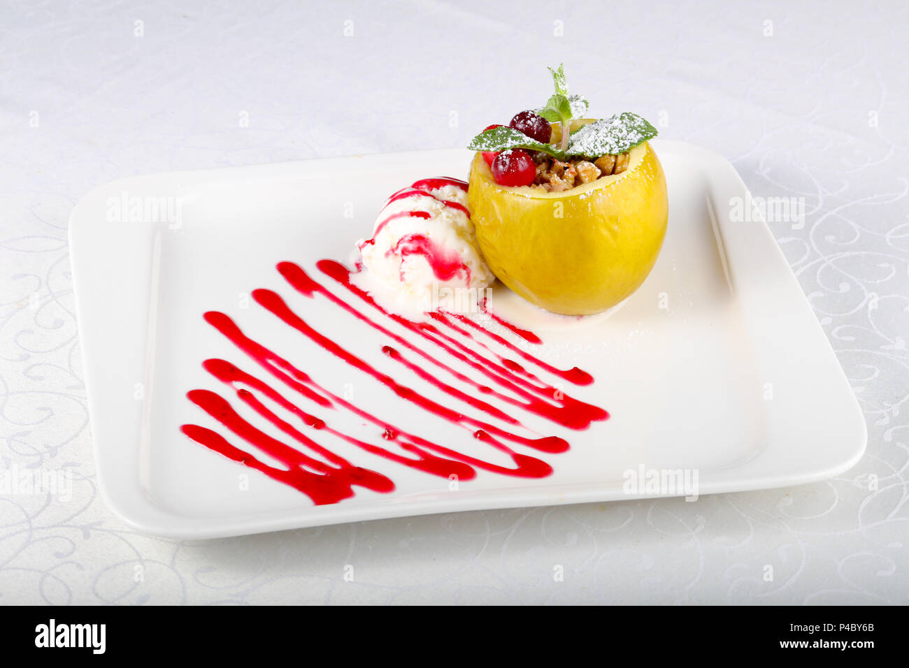 Apple stuffed nuts with ice-cream Stock Photo - Alamy
