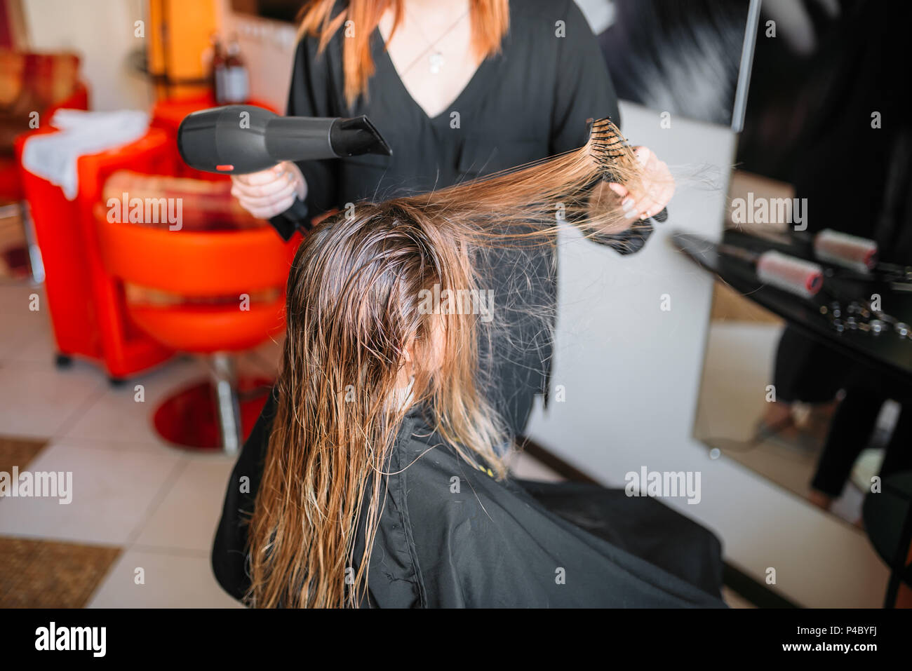 Hairdresser drying hair, female hairdressing Stock Photo - Alamy