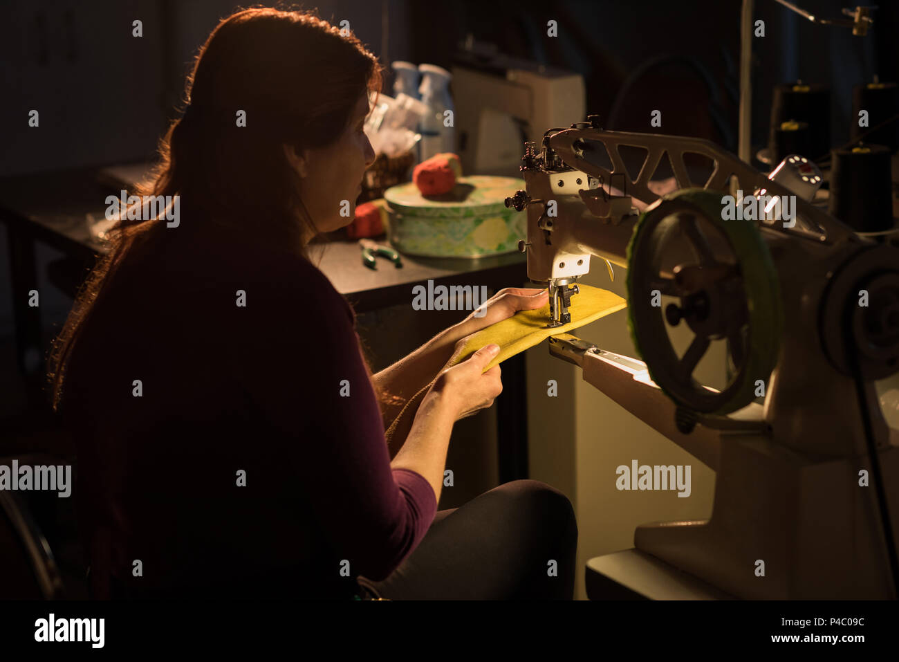 Tailor sewing cloth with sewing machine Stock Photo - Alamy