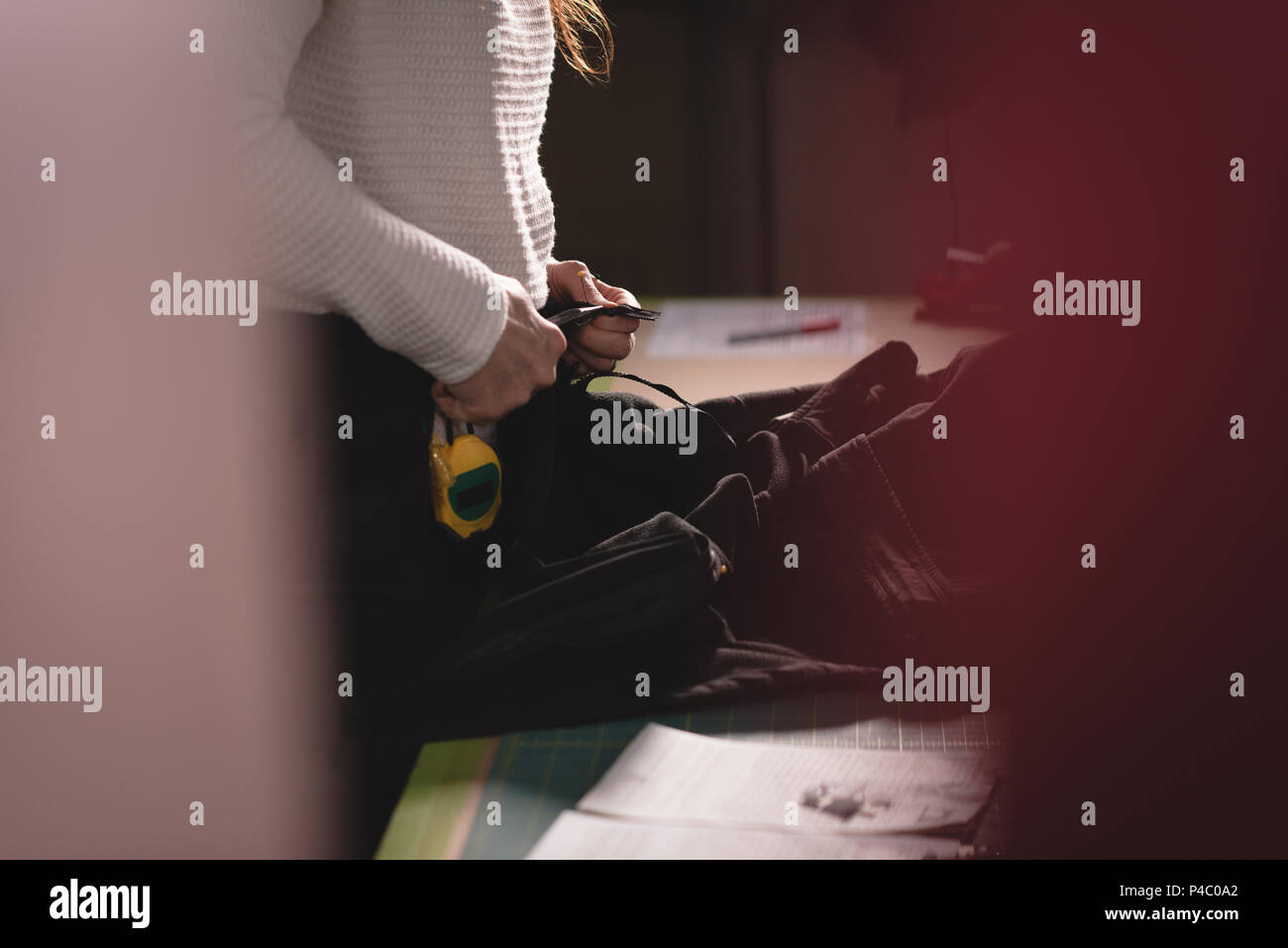 Tailor checking clothes at tailor shop Stock Photo - Alamy