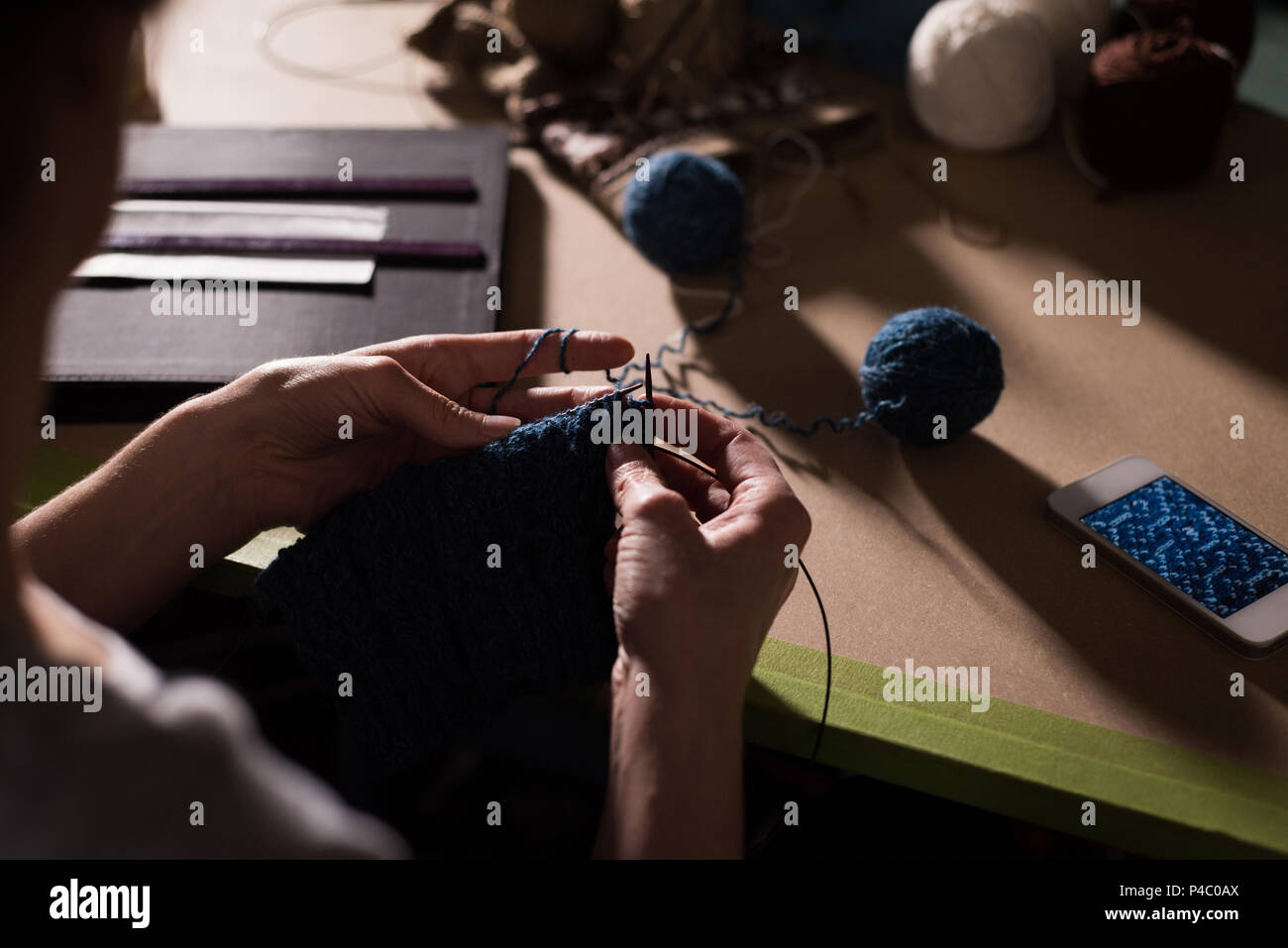 Woman knitting wool at tailor shop Stock Photo - Alamy
