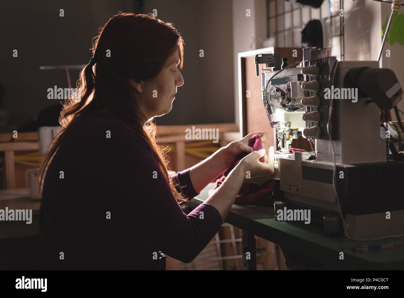 Tailor sewing cloth with sewing machine Stock Photo - Alamy