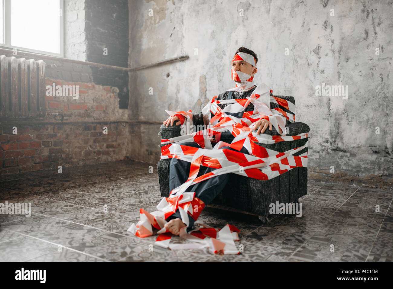 Autistic sitting on a chair in the middle of room Stock Photo - Alamy