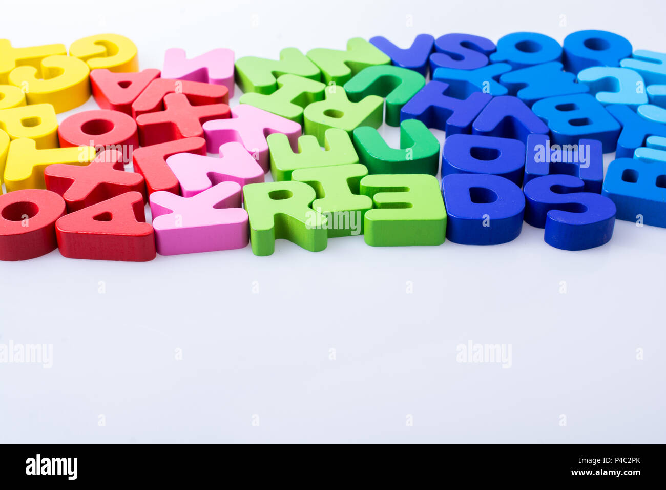 Colorful alphabet letter blocks scattered randomly on white background ...