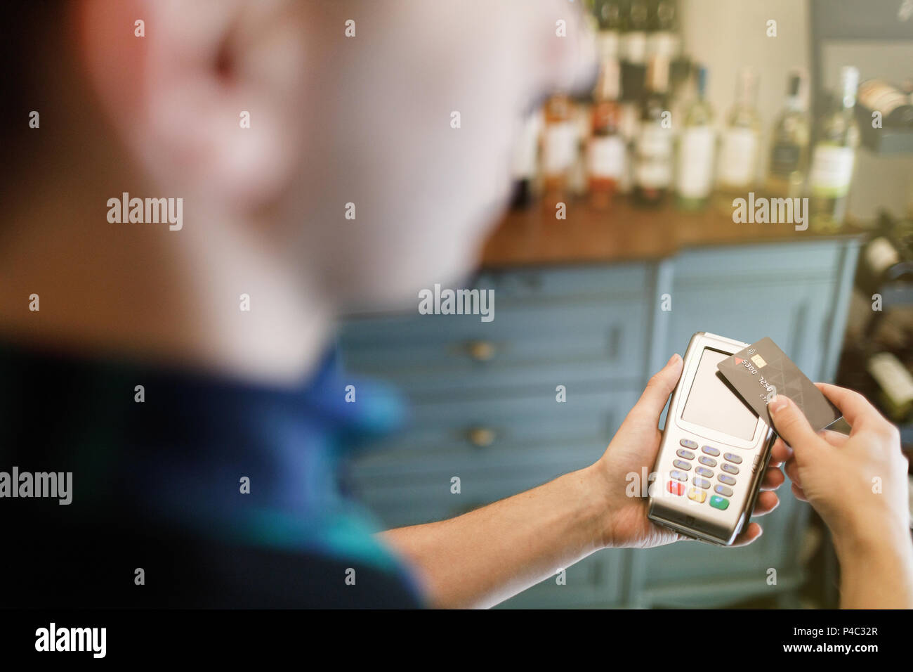 Hand of customer paying with contactless credit card with NFC te Stock ...