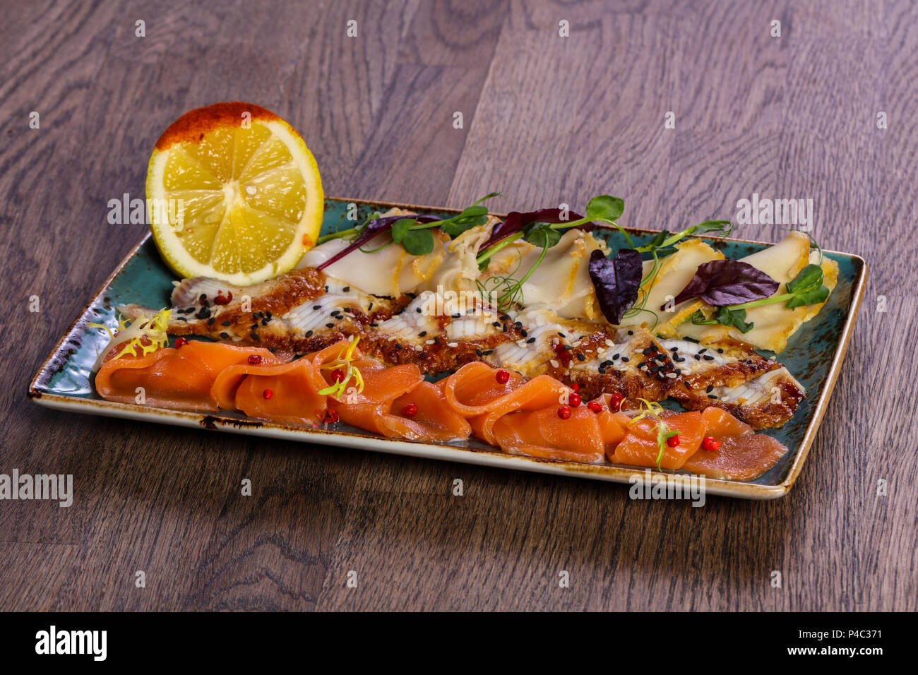 Sliced fish plate served lemon Stock Photo - Alamy