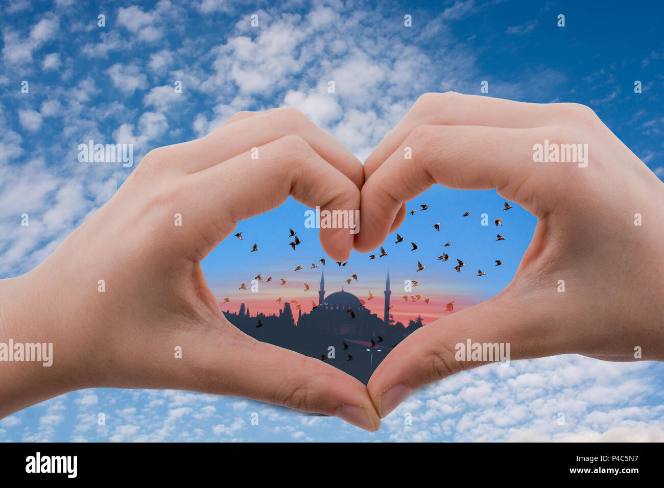 Islamic mosque view seen behind a heart shaped hand Stock Photo - Alamy