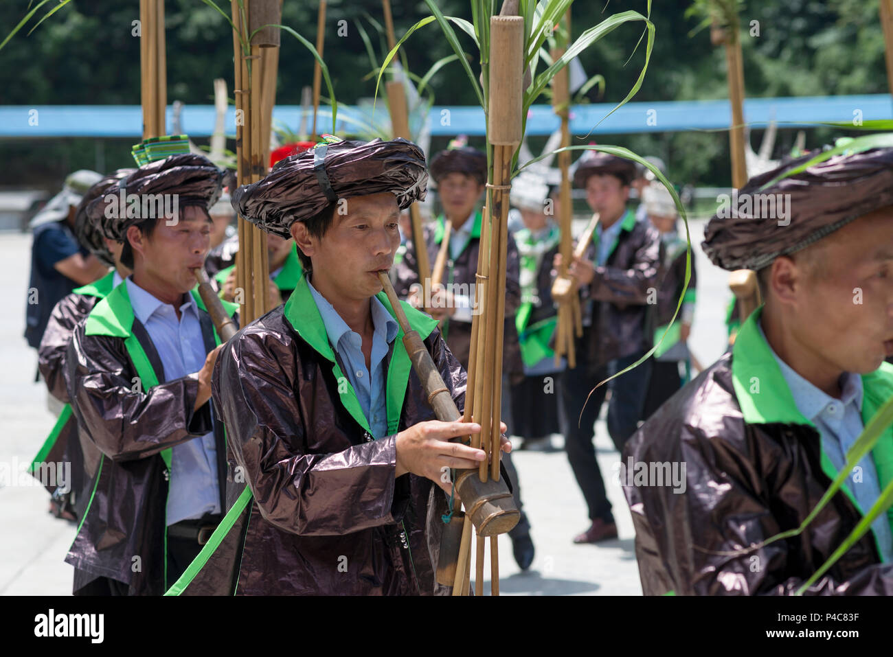 Musicians playing bamboo wind instruments at celebration, Xiaoao Miao ...