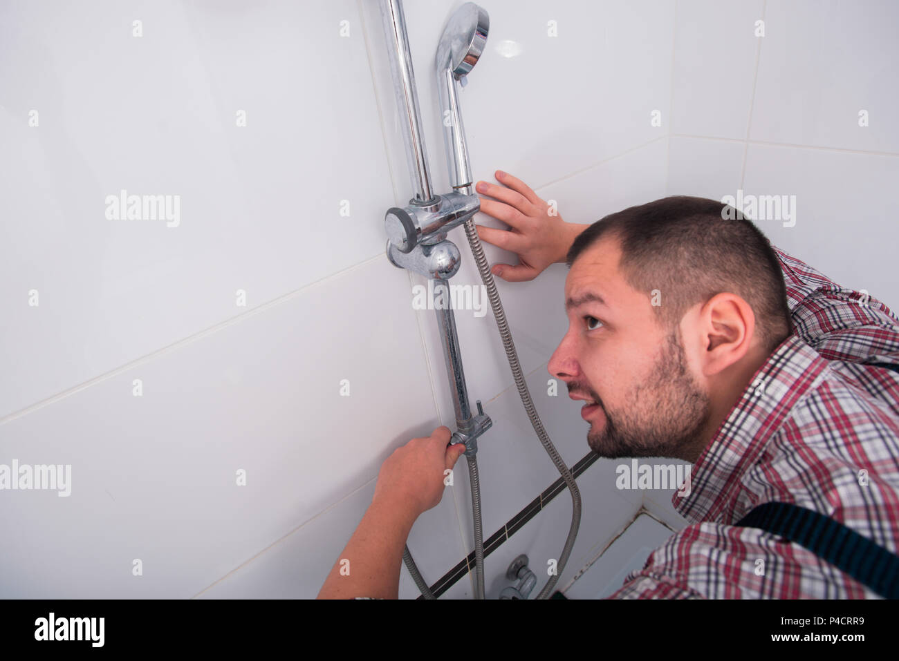 Handyman fixing the shower the bathroom Stock Photo - Alamy