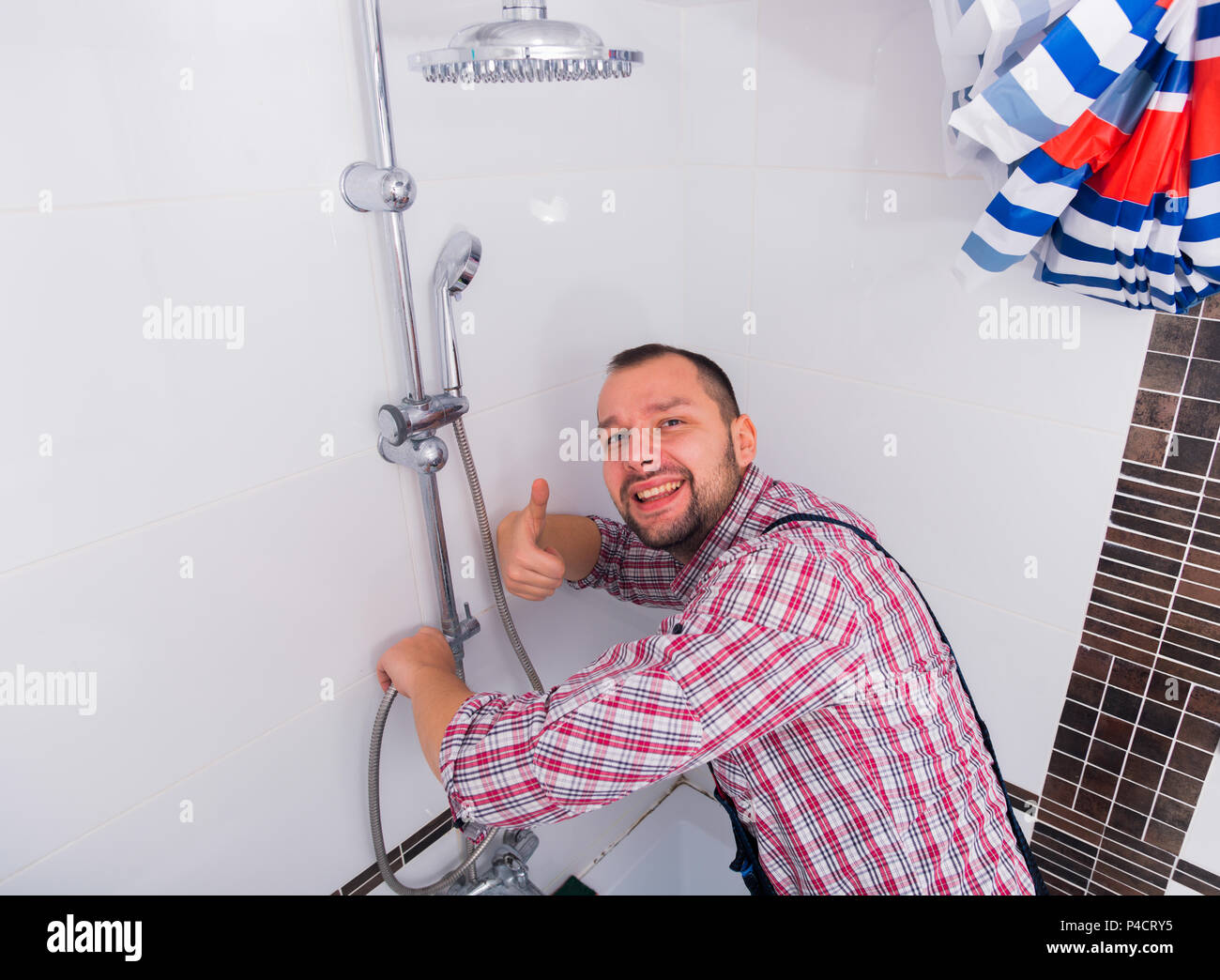Handyman fixing the shower the bathroom Stock Photo - Alamy